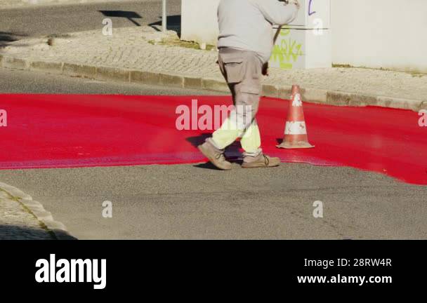 Process of painting for speed restricting road surface marking with red ...