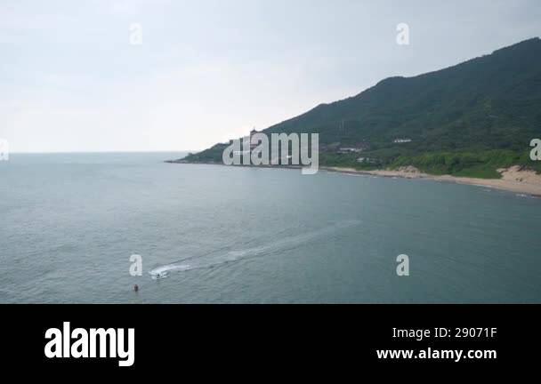 A serene and tranquil beach scene features a majestic mountain ...