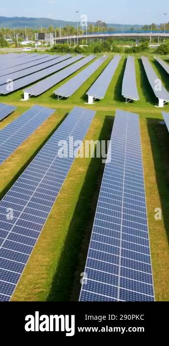 Rows of gleaming solar panels stretch across lush green fields in ...