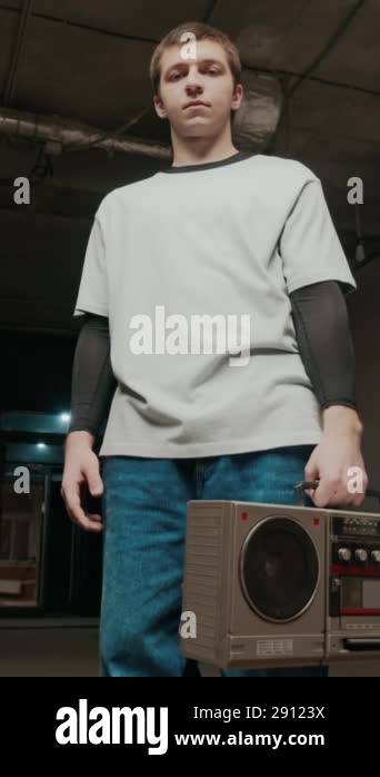 Vertical arc portrait of Caucasian gen Z boy in urbanwear standing ...