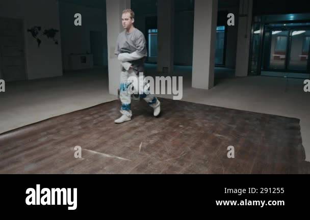Stab shot of skilled Caucasian gen Z b-boy in street style clothes ...