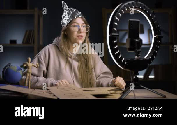 Strange crazy vlogger with cellphone, paranoid woman streaming at home ...