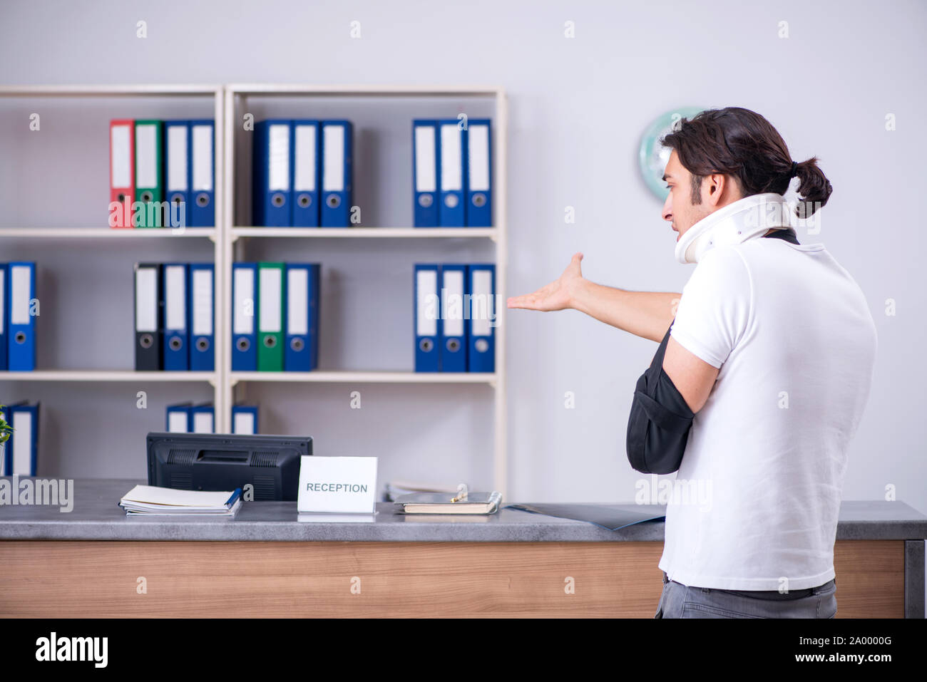 Clinic reception counter and young patient Stock Photo - Alamy