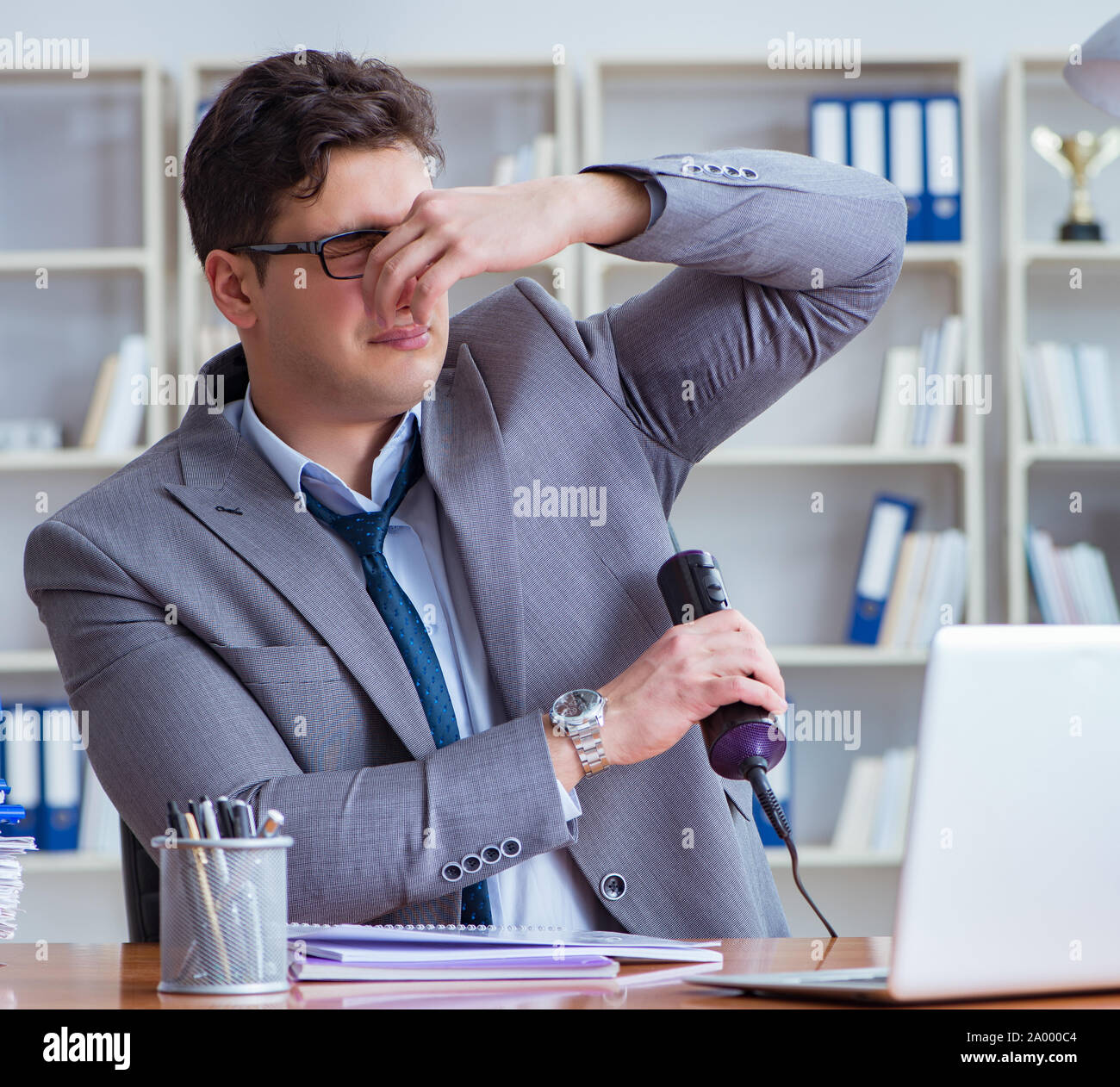 Businessman sweating excessively smelling bad in office at workplace ...