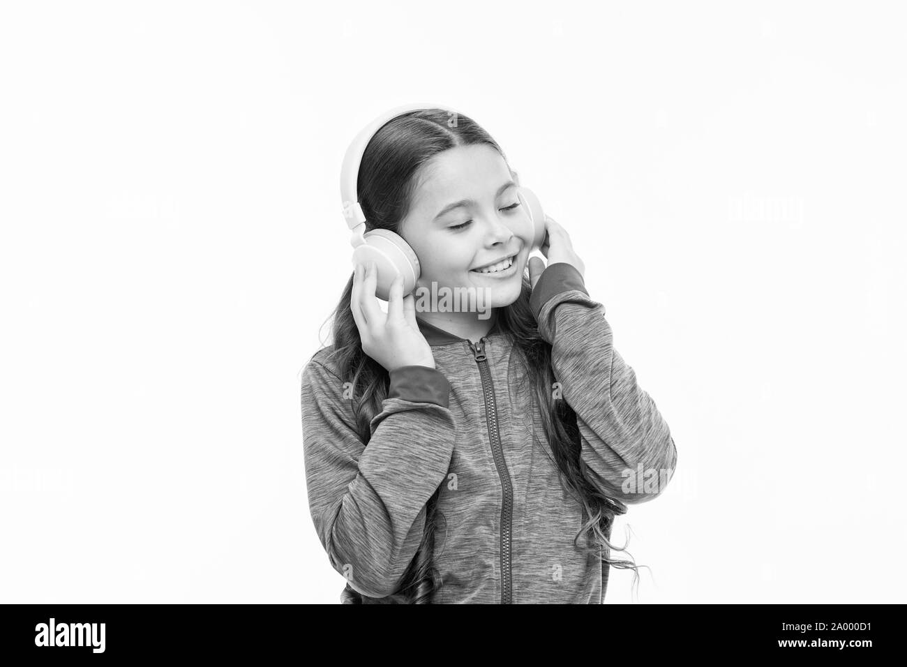 Tuning into a wave of real sound. Cute kid listening to sound track ...