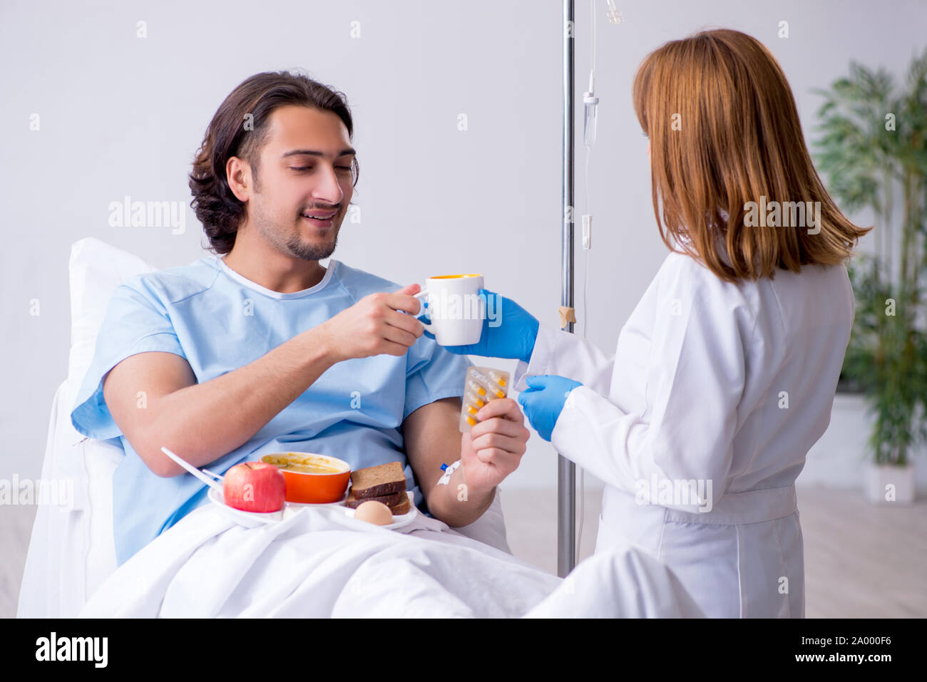 The male patient eating food in the hospital Stock Photo - Alamy