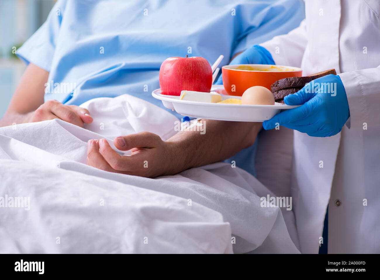 The male patient eating food in the hospital Stock Photo - Alamy