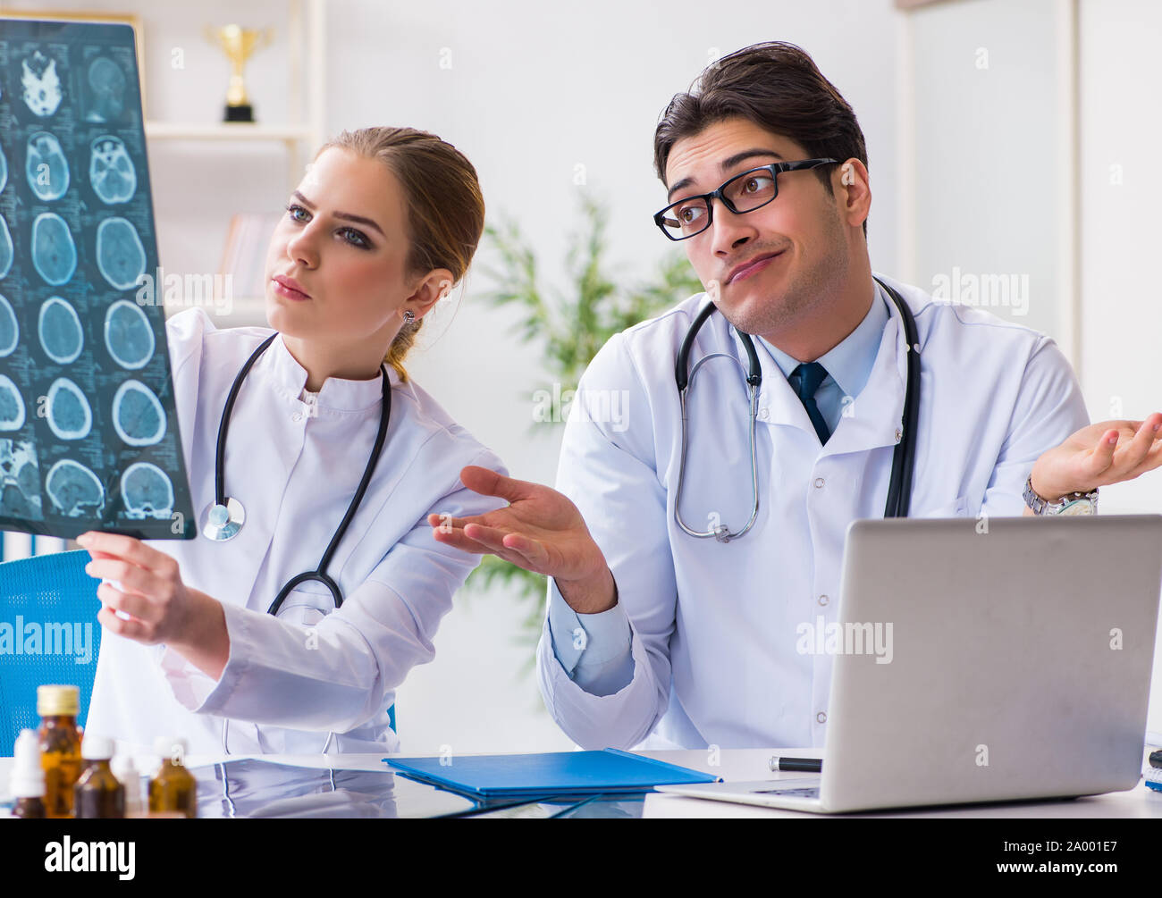 The two doctors examining x-ray images of patient for diagnosis Stock ...