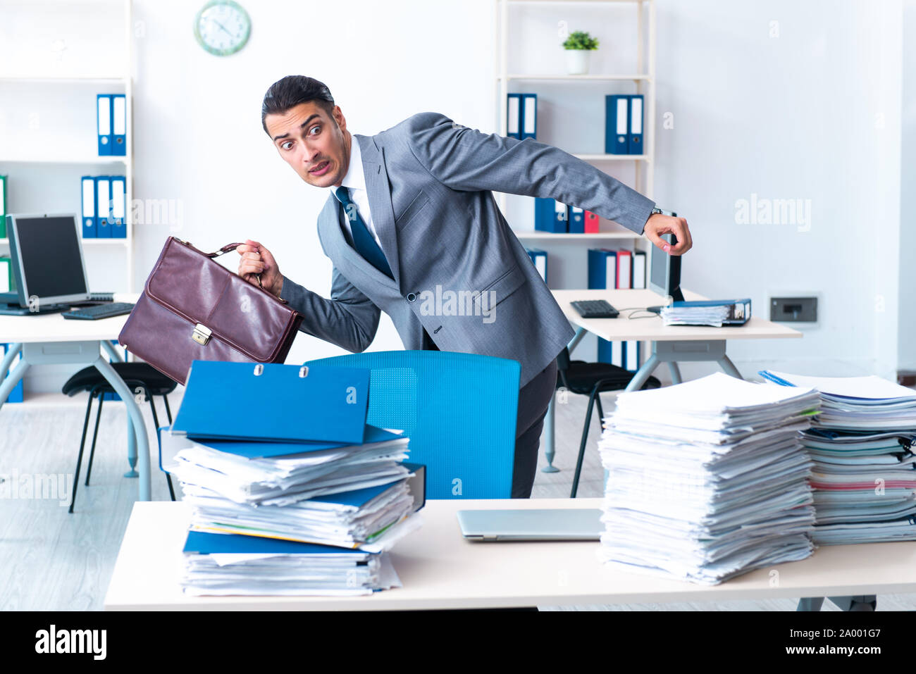 The businessman with heavy paperwork workload Stock Photo - Alamy