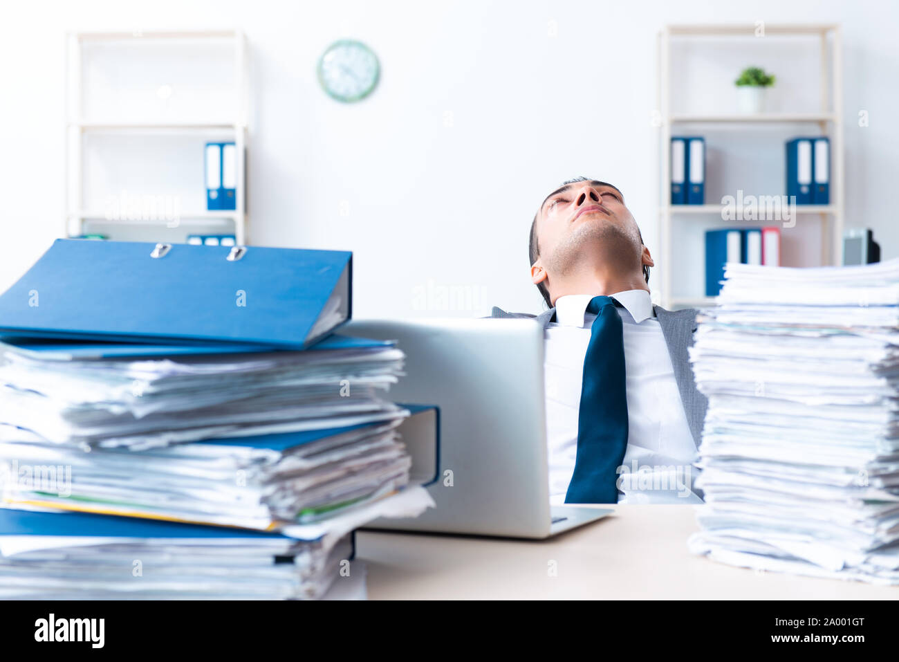 The businessman with heavy paperwork workload Stock Photo - Alamy