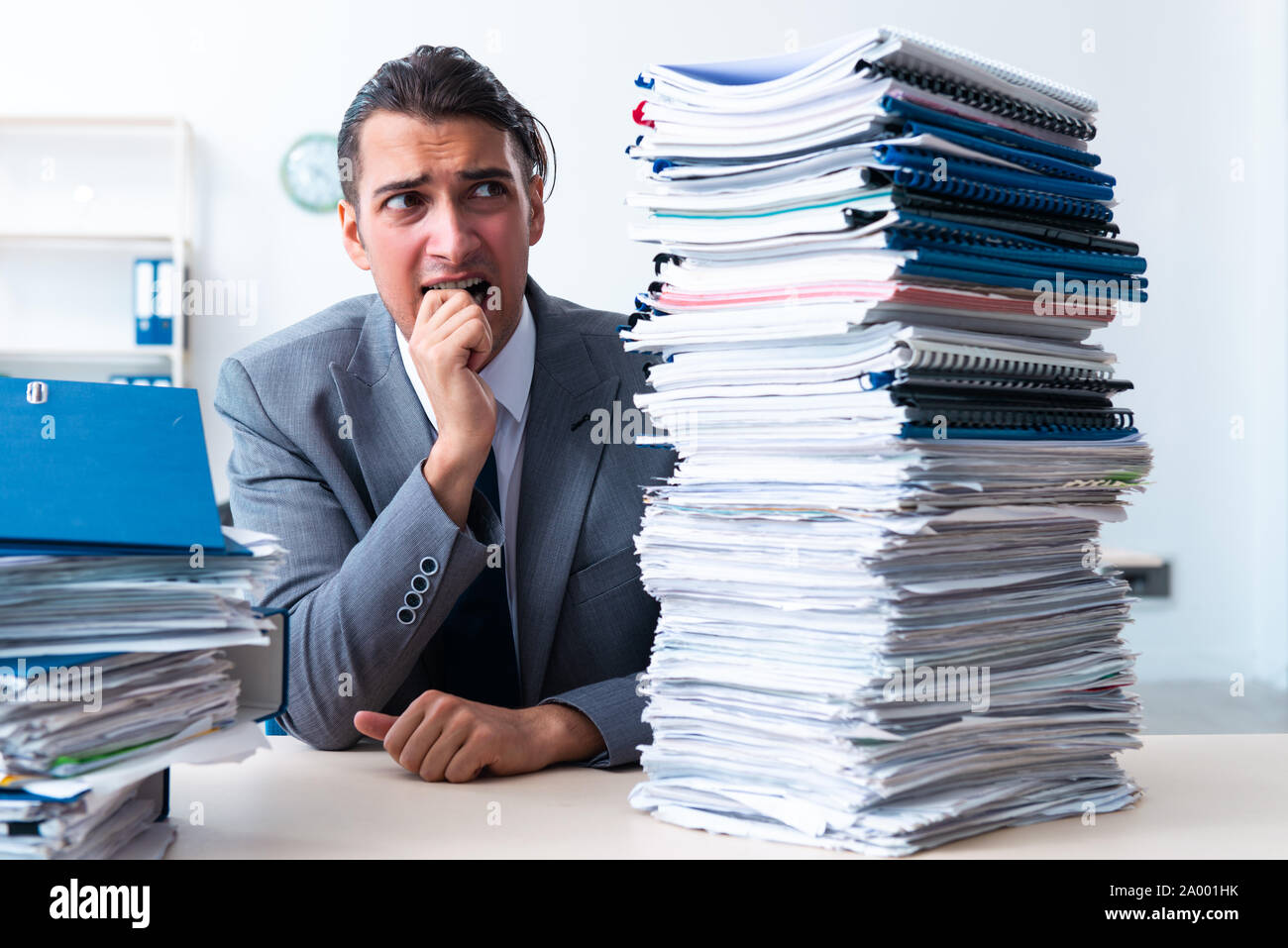 The businessman with heavy paperwork workload Stock Photo - Alamy