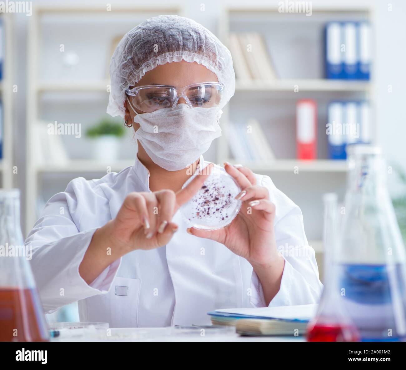 Female scientist researcher conducting an experiment in a laboratory ...