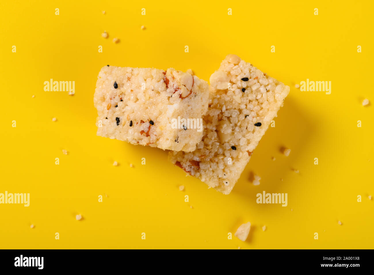 top view traditional Chinese crisp rice block with peanuts on yellow ...