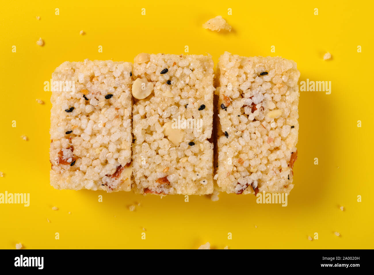 top view traditional Chinese crisp rice block with peanuts on yellow ...