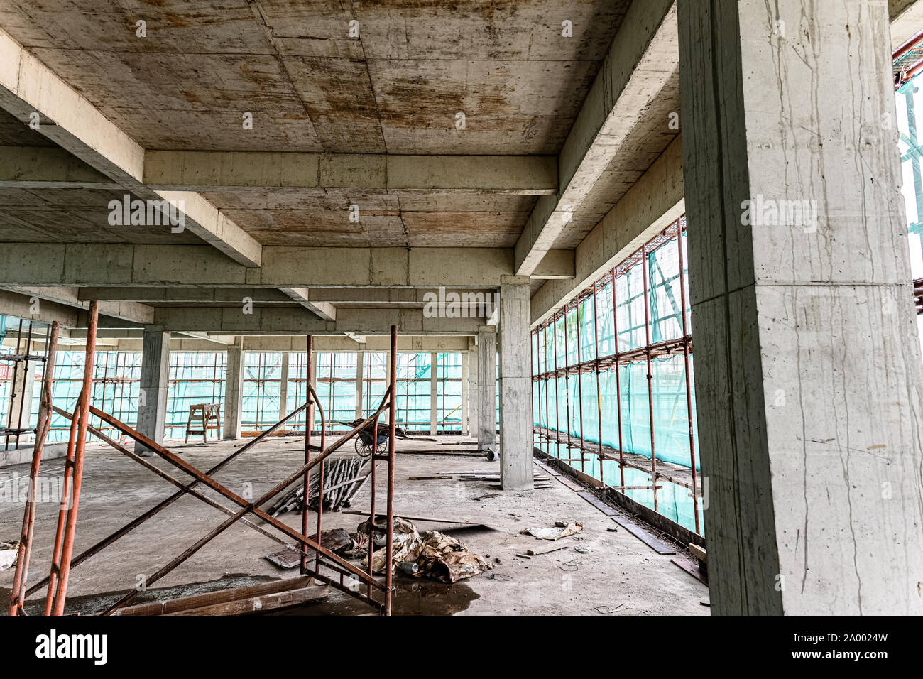 inside of an unfinshed building with protection scaffolding and netting ...