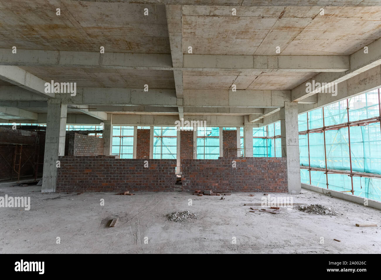 inside of an unfinshed building with protection scaffolding and netting ...