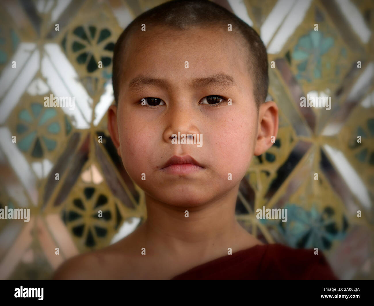 Serious Burmese Buddhist boy monk at Su Taung Pyae pagoda poses for a ...