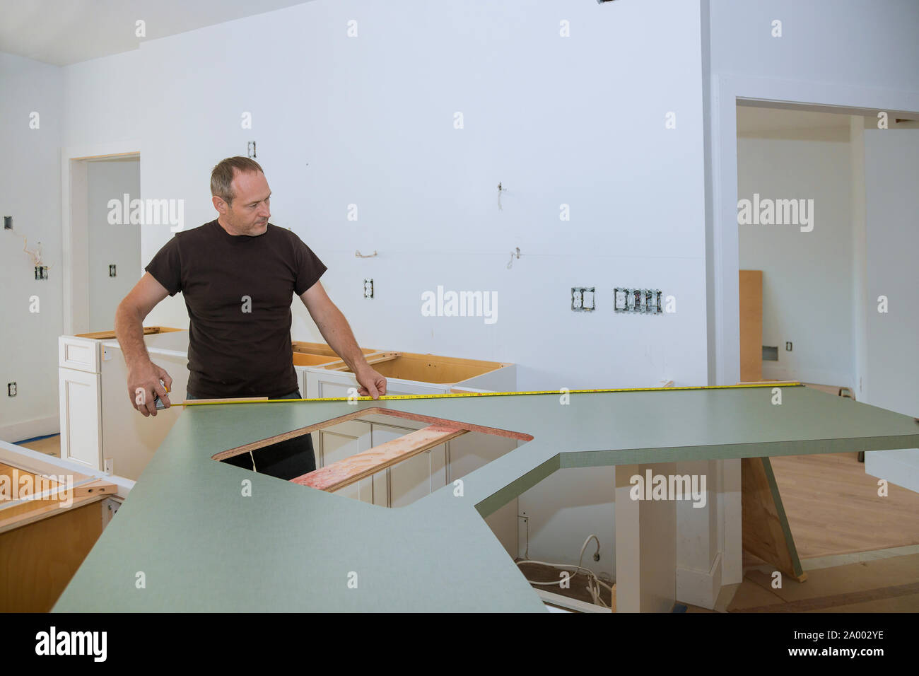 Man using tape to measure cabinet hi-res stock photography and images ...