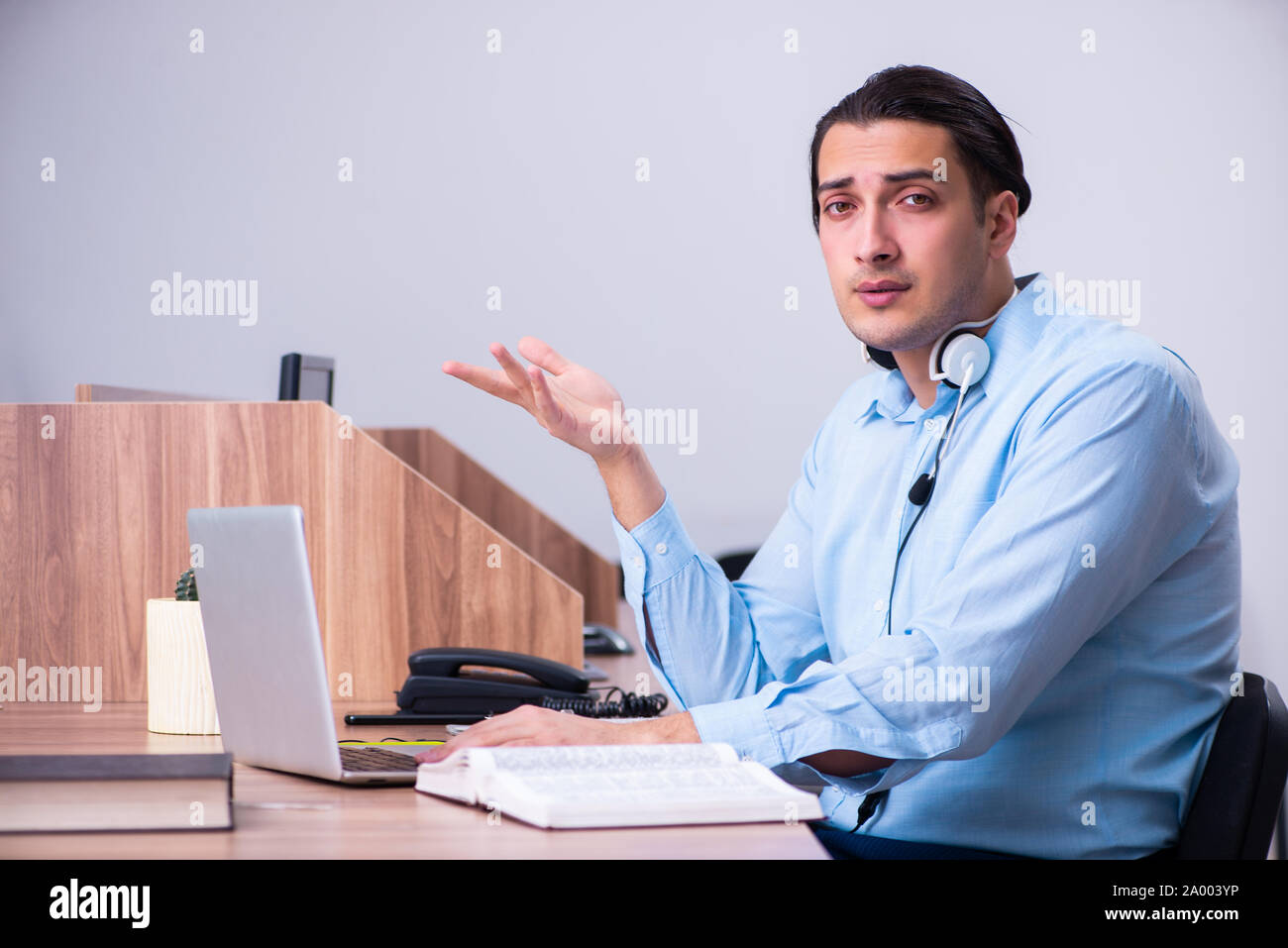 The call center operator working at his desk Stock Photo - Alamy