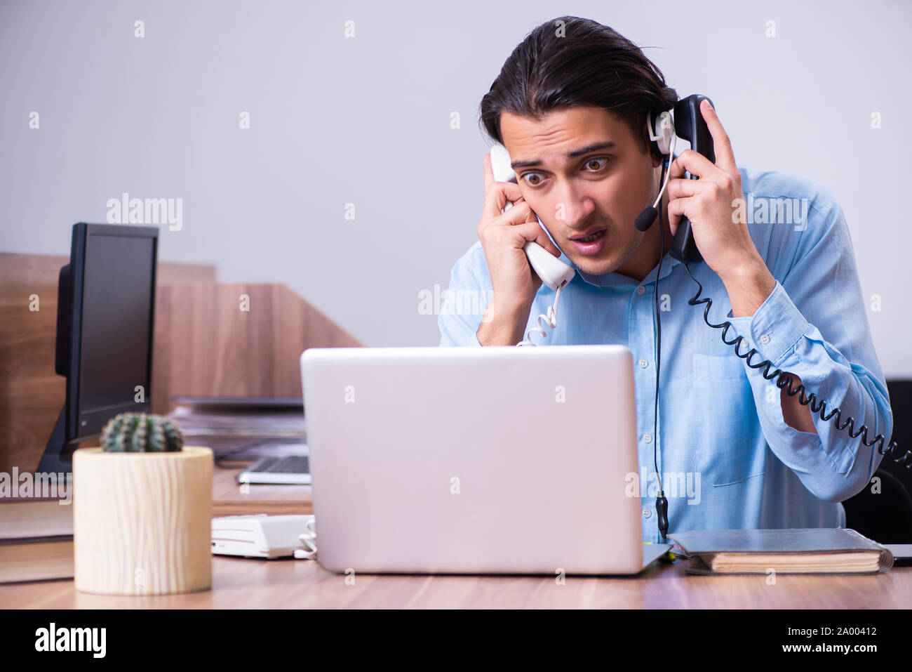 The call center operator working at his desk Stock Photo - Alamy