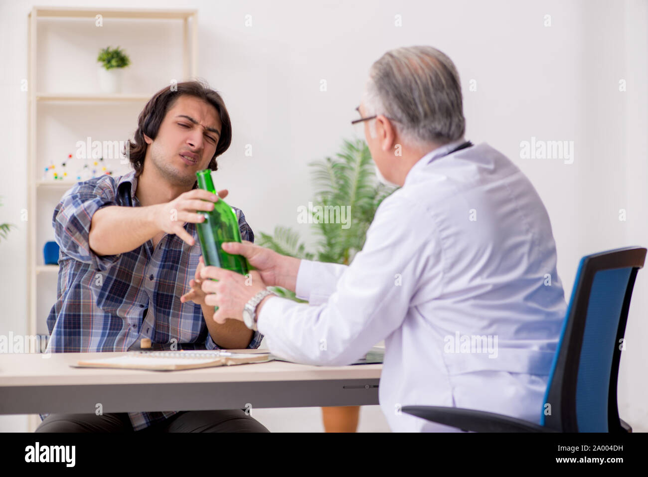 The young male alcoholic visiting old doctor Stock Photo - Alamy