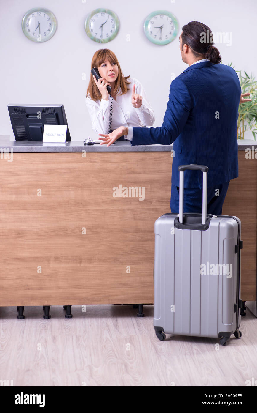 The young businessman at hotel reception Stock Photo - Alamy