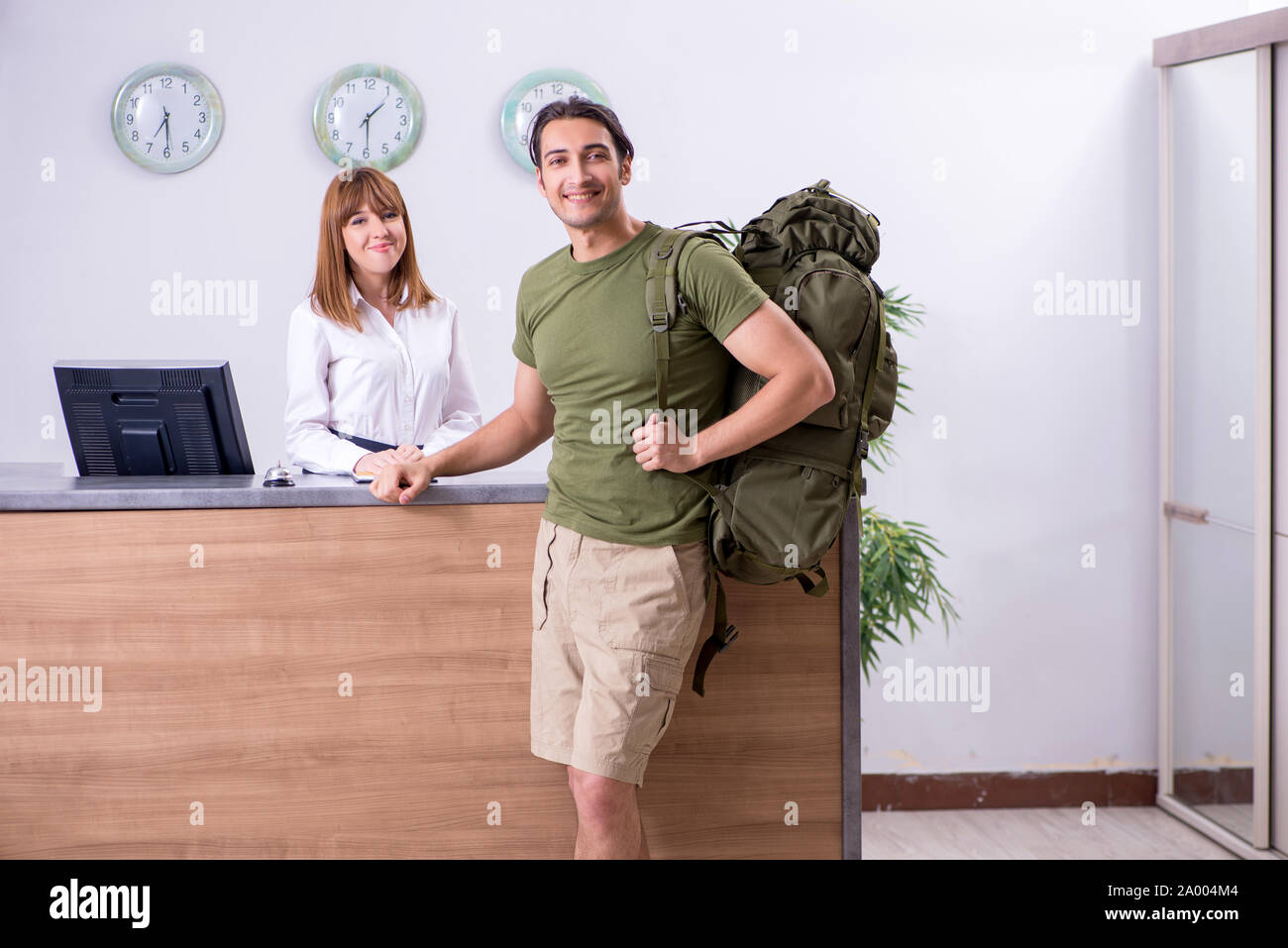 The young man at the hotel reception Stock Photo - Alamy