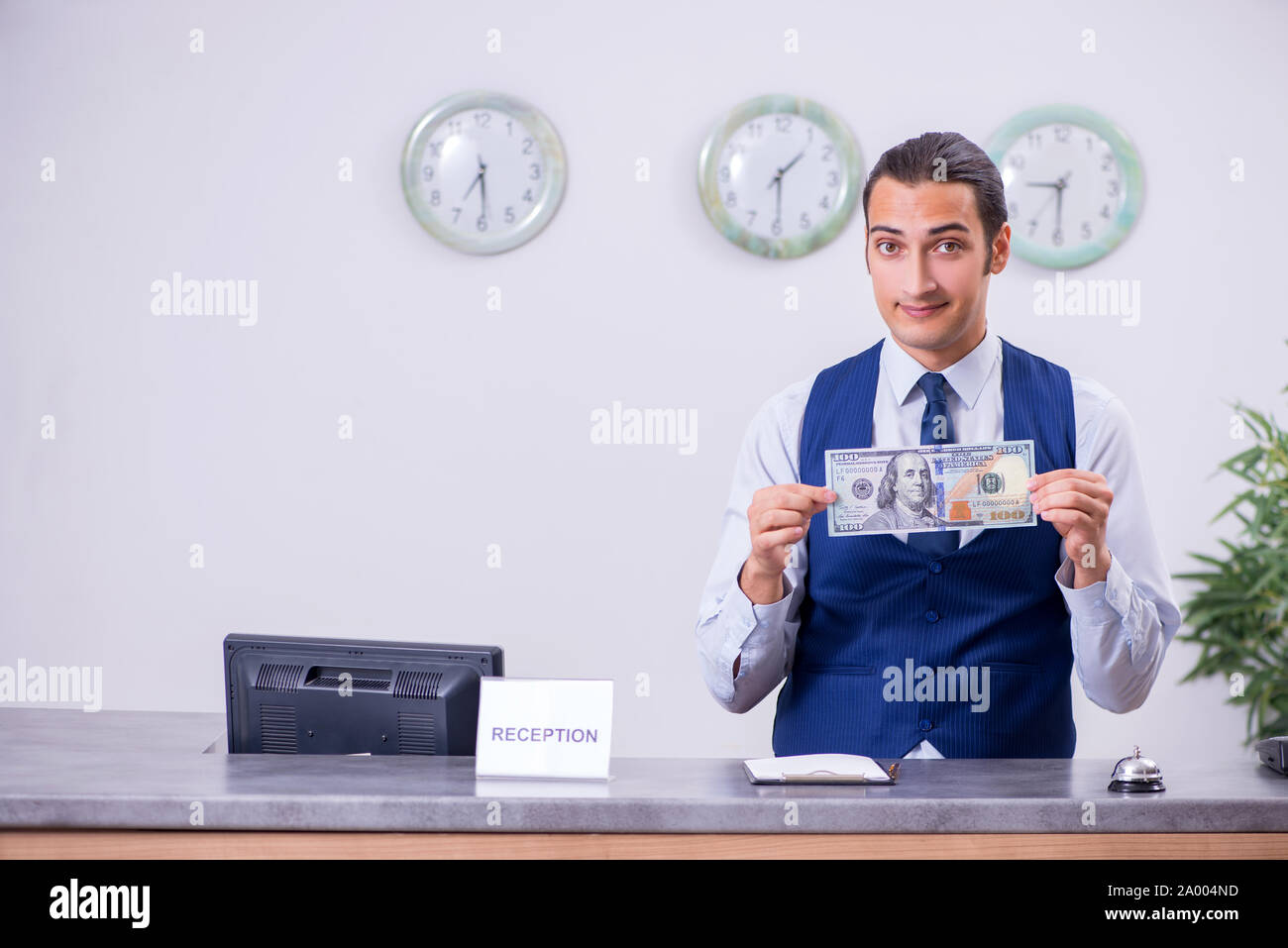 The young man receptionist at the hotel counter Stock Photo - Alamy