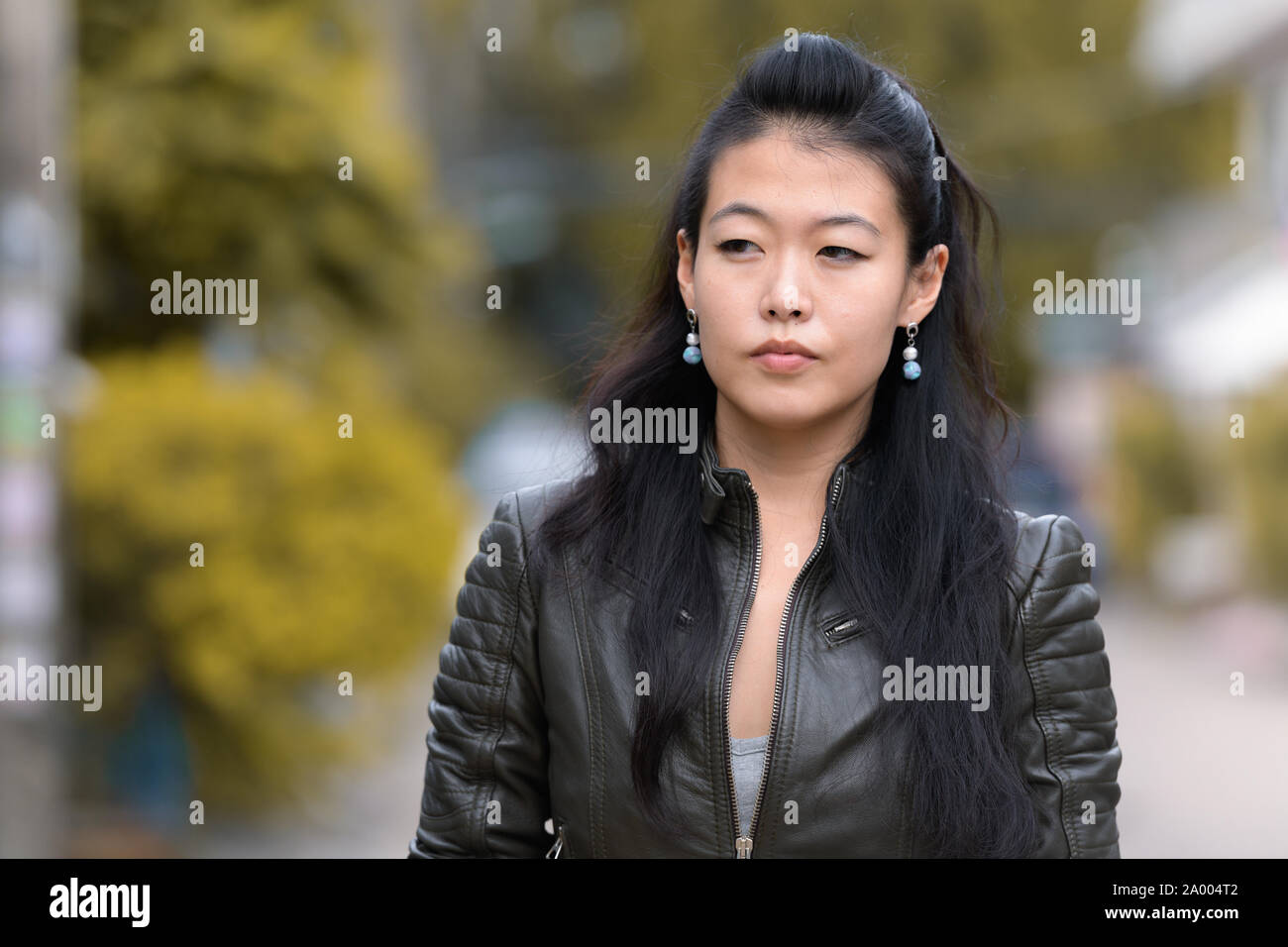 Face of beautiful Asian rebellious woman thinking outdoors Stock Photo ...