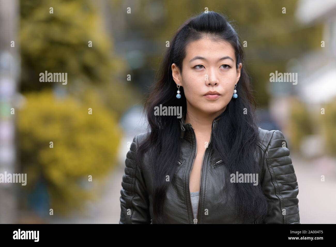 Face of beautiful Asian rebellious woman thinking outdoors Stock Photo ...