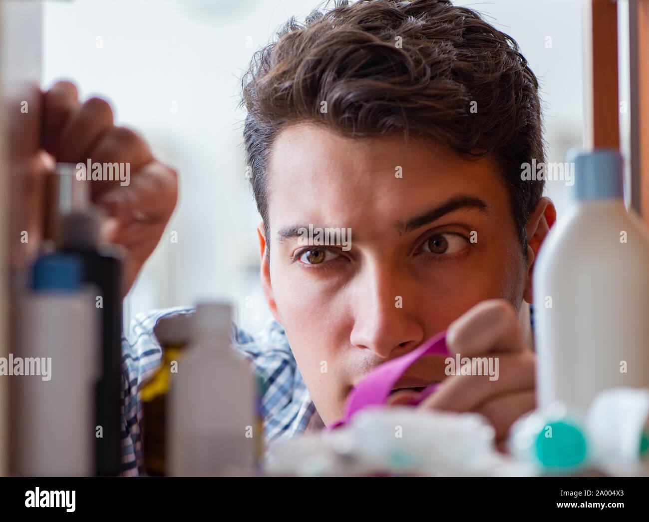 The sick ill man looking for medicines at farmacy shelf Stock Photo - Alamy