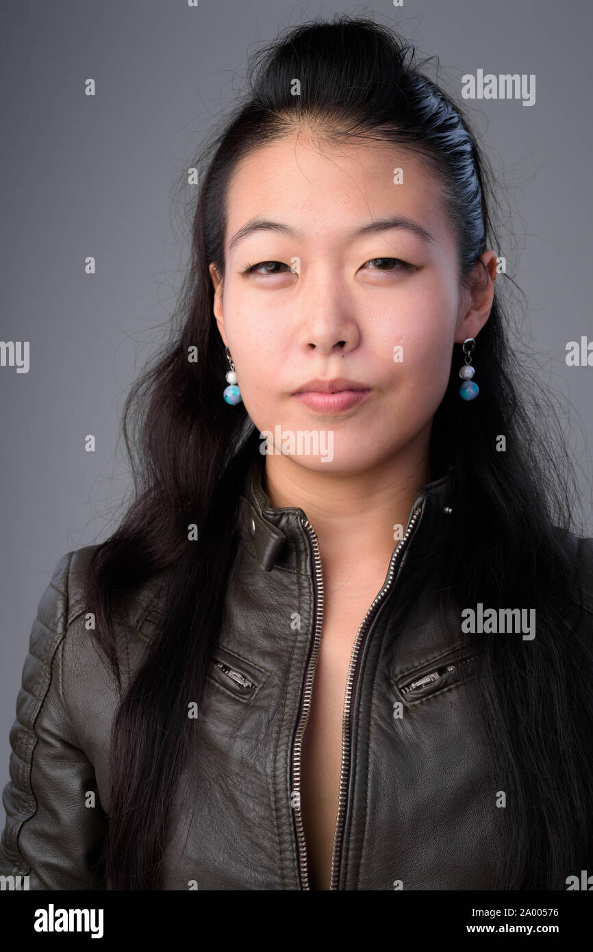 Face of beautiful Asian rebellious woman with leather jacket Stock ...