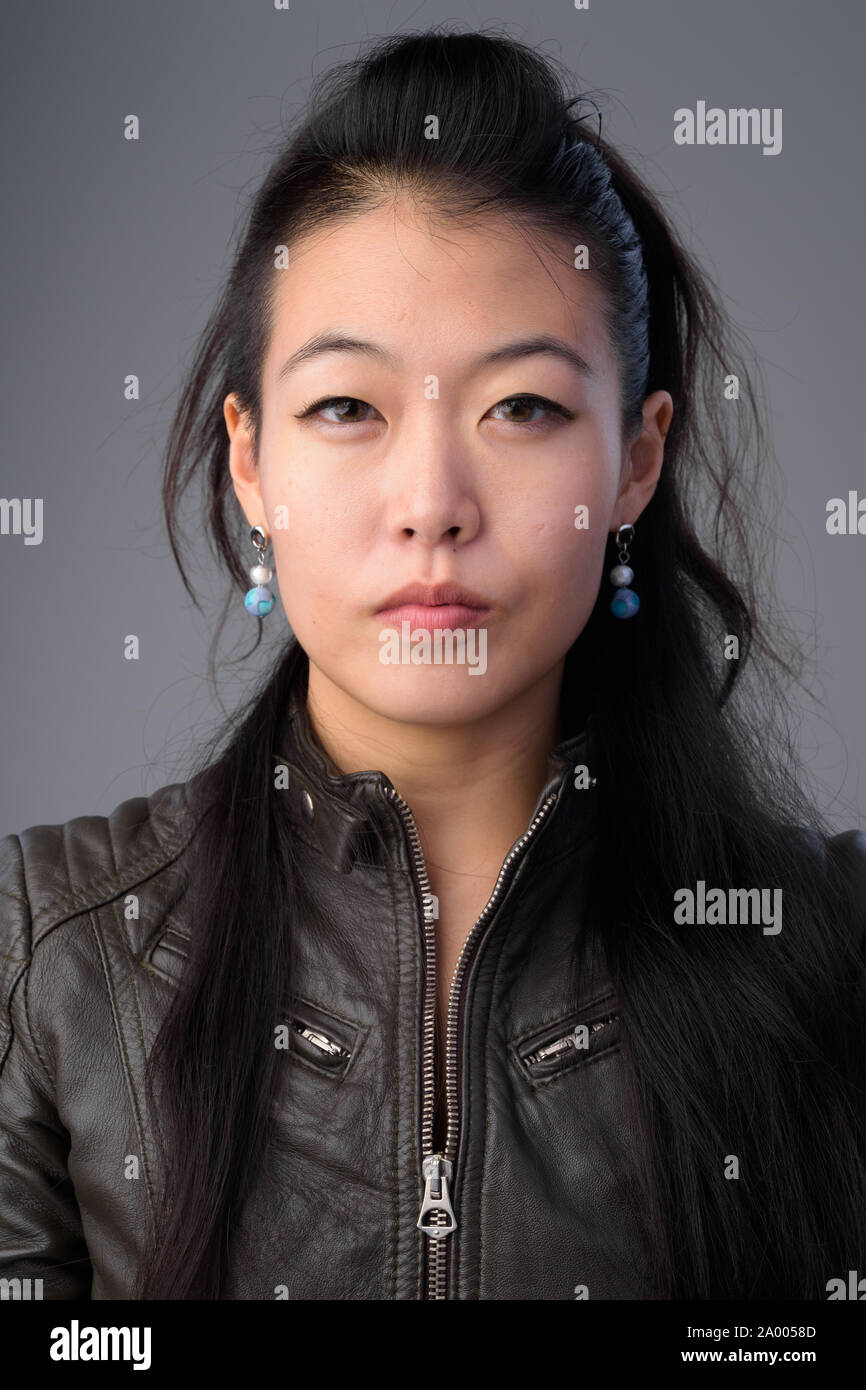 Face of beautiful Asian rebellious woman with leather jacket Stock ...