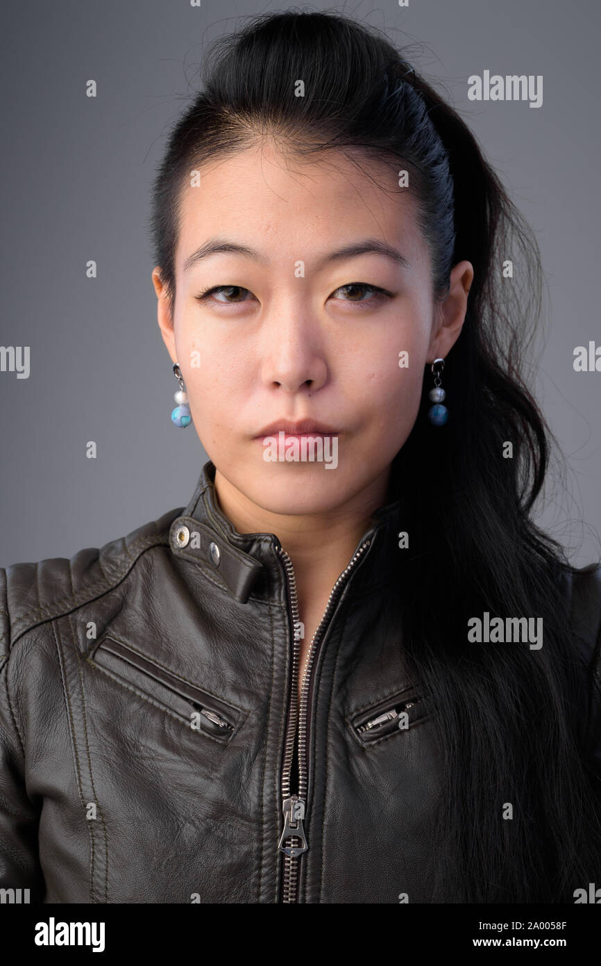 Face of beautiful Asian rebellious woman with leather jacket Stock ...