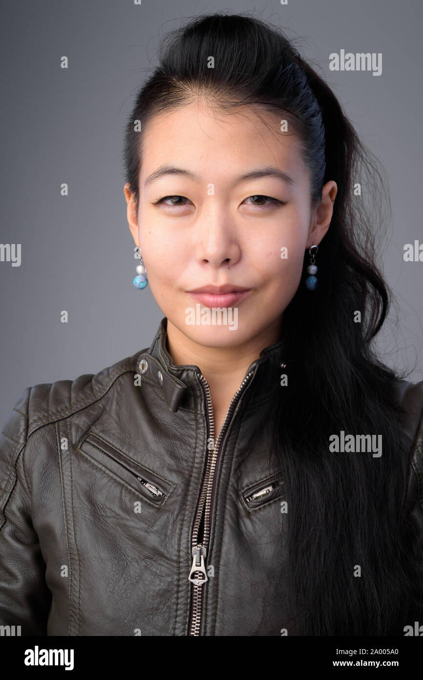Face of beautiful Asian rebellious woman with leather jacket Stock ...