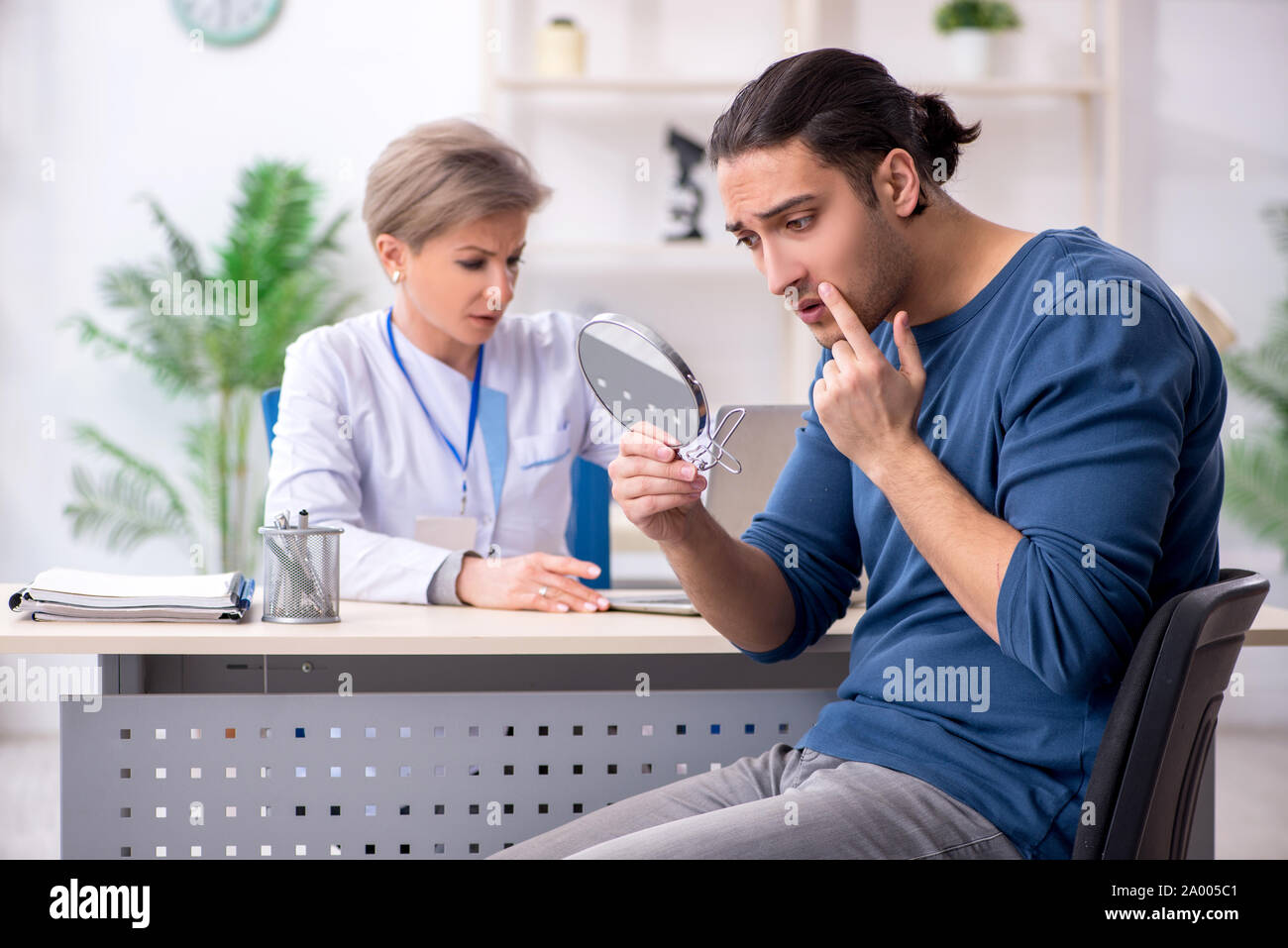 Young woman mirror face inspecting hi-res stock photography and images ...