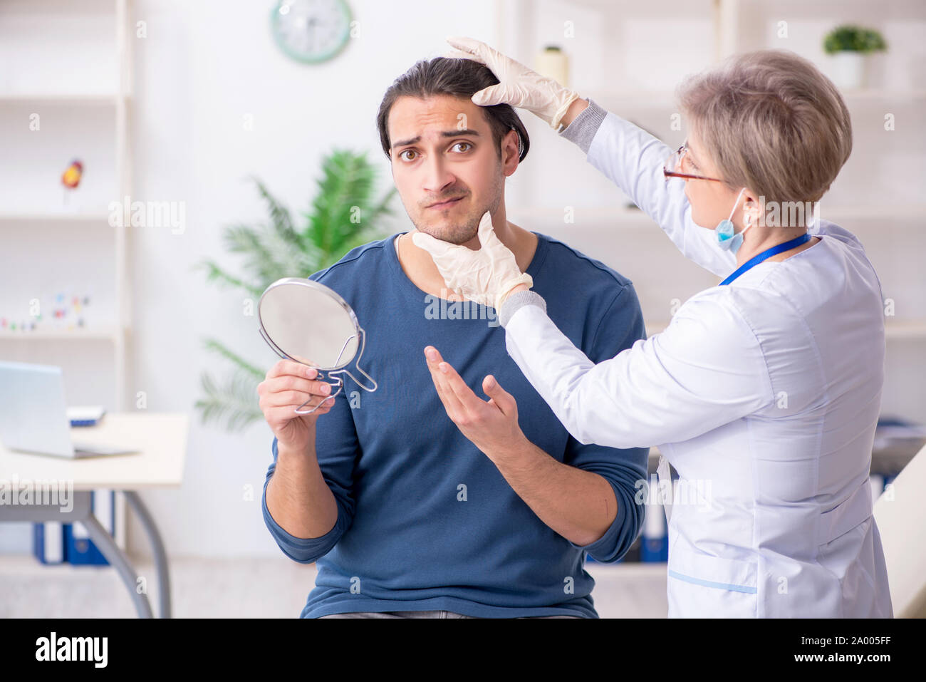 Young woman mirror face inspecting hi-res stock photography and images ...