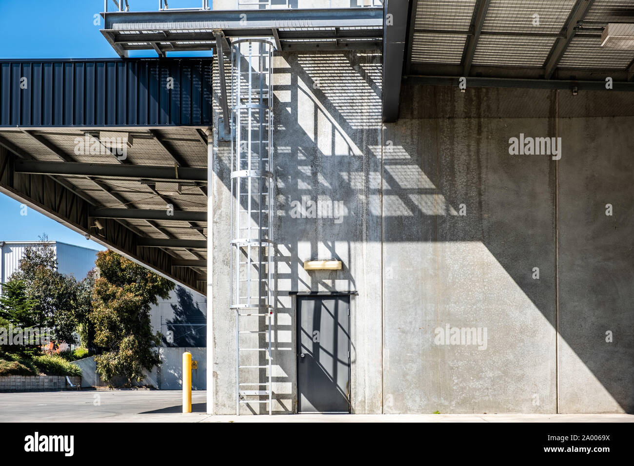 Industrial concrete warehouse back door entrance with emergency fire ...