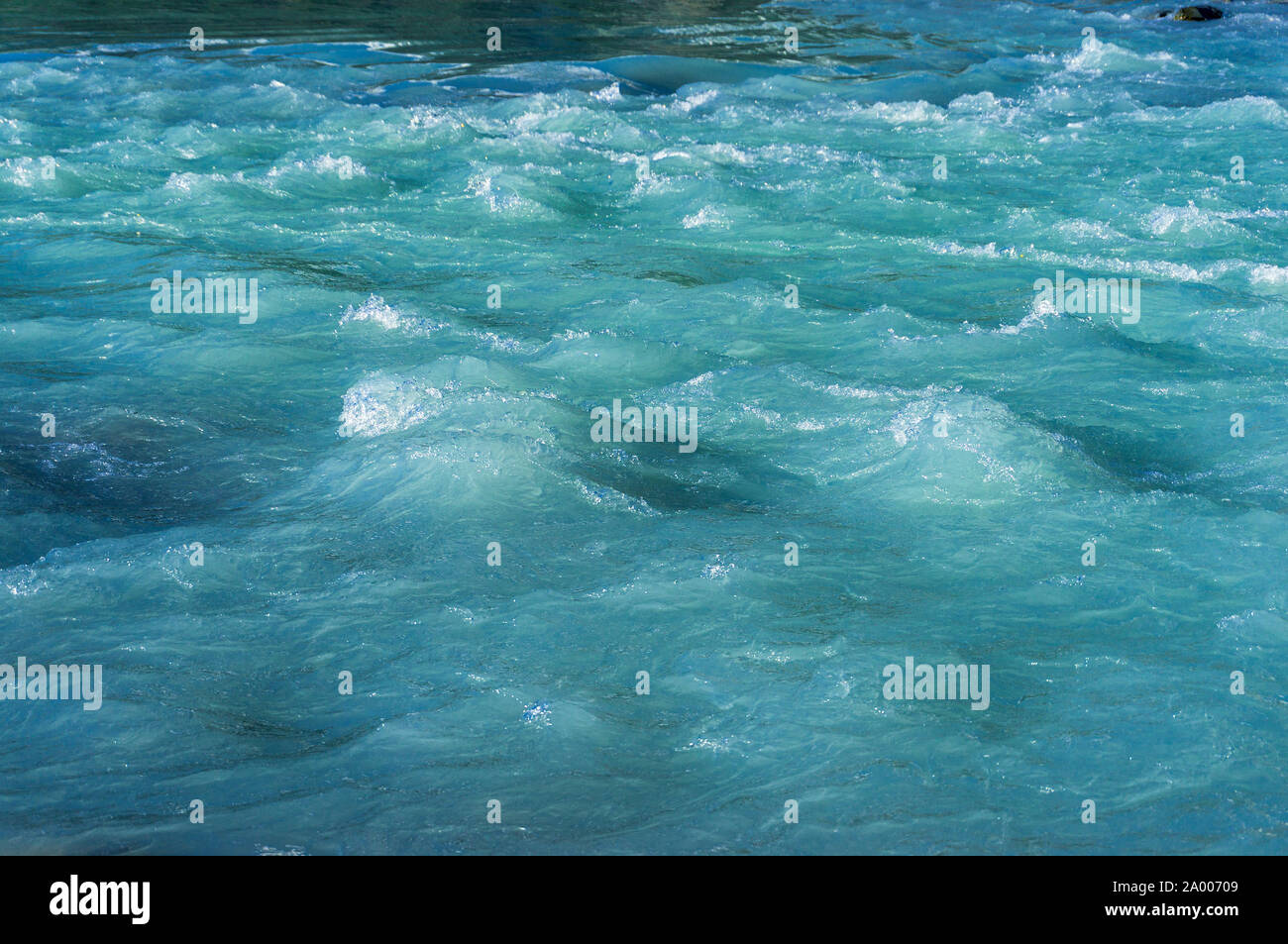 Icy cold water of glacier lake stream. Cold blue water stream closeup ...