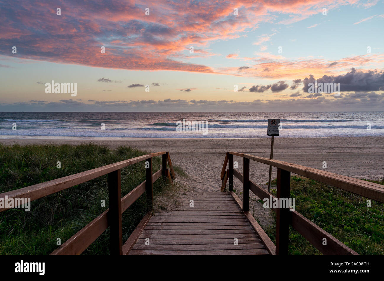 Sunrise ocean beach. Sea beach wooden walkway, path entrance. Sandy ...