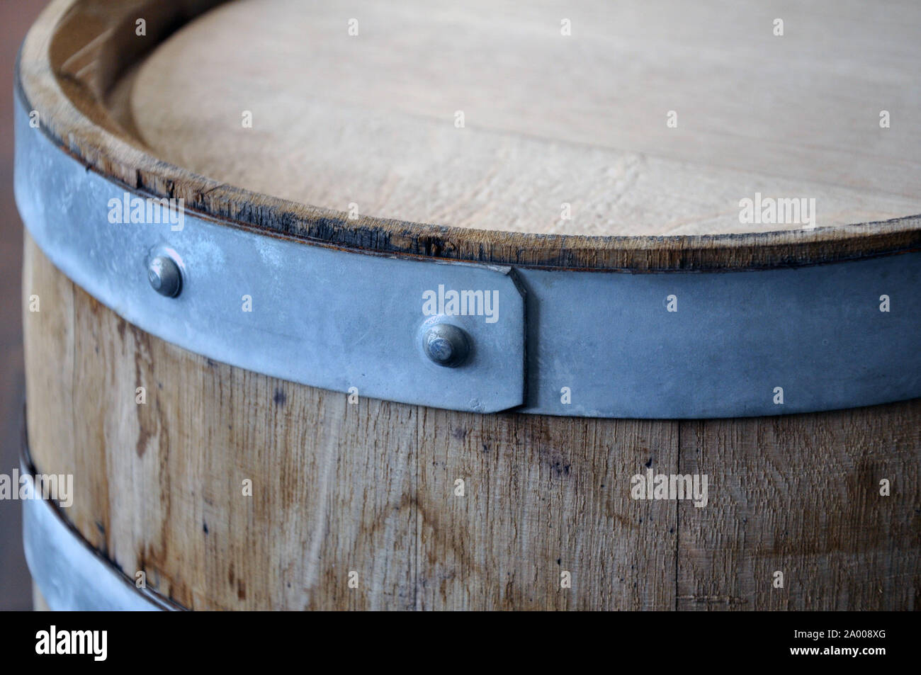 New oak barrel with young wine, cap and rivets. Winemaking and home ...
