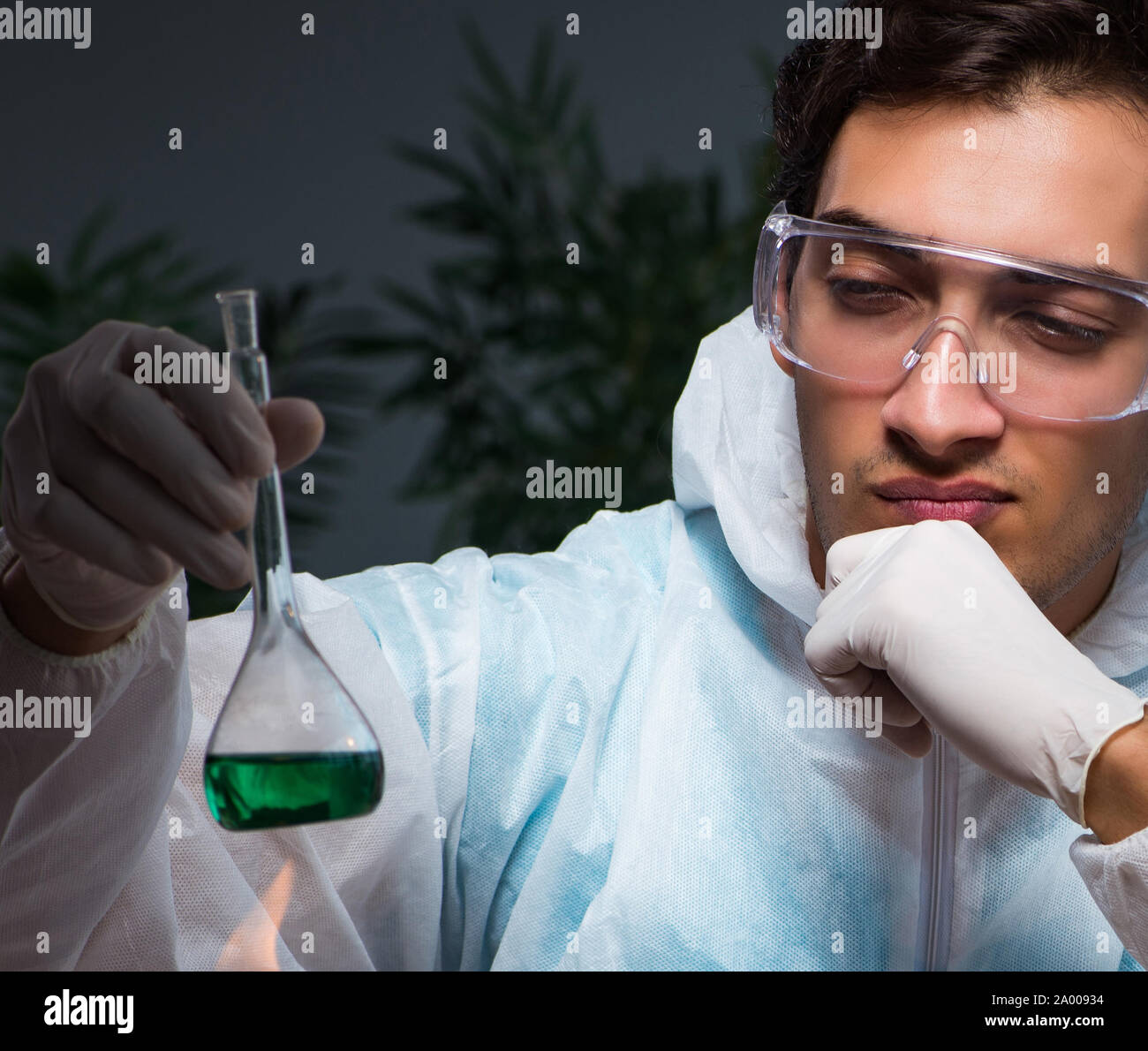 The young male lab chemist late at night in overtime time Stock Photo ...