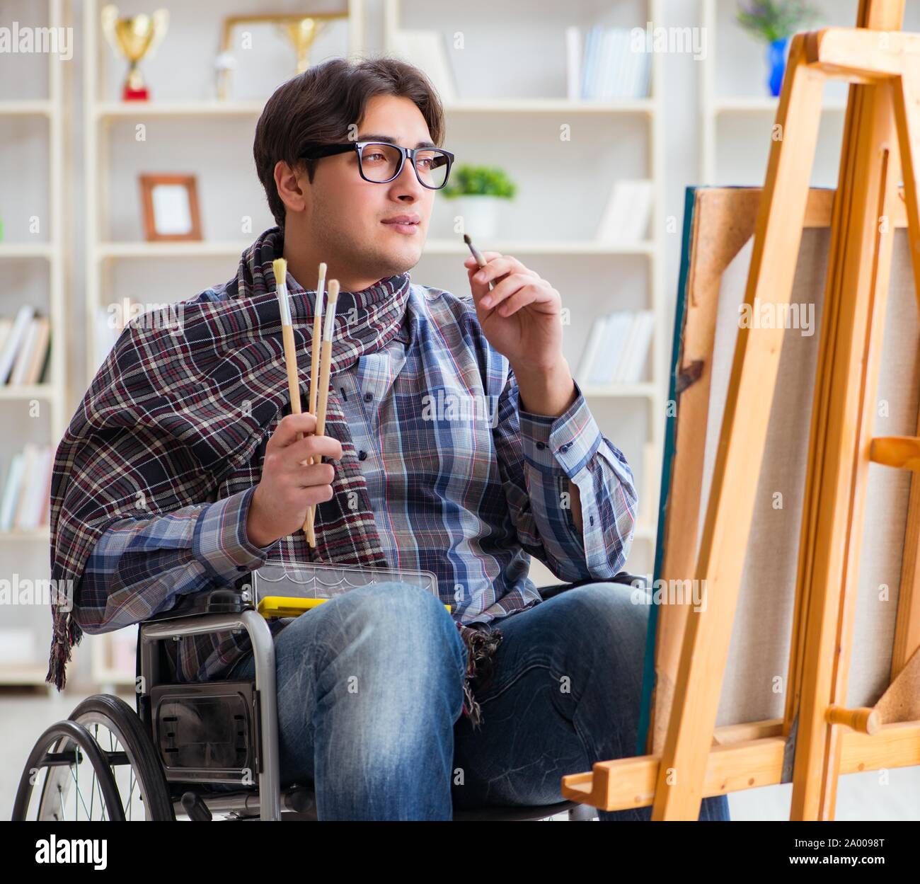 The disabled artist painting picture in studio Stock Photo - Alamy