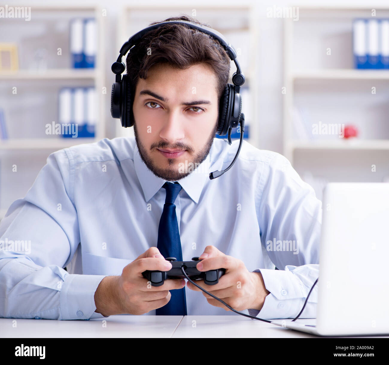 The businessman gamer in office playing games Stock Photo - Alamy