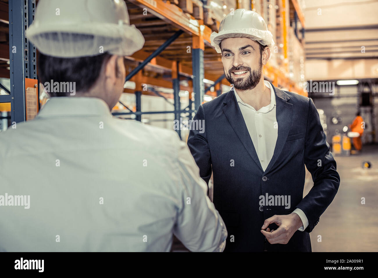 Joyful young manager talking to his employee Stock Photo - Alamy