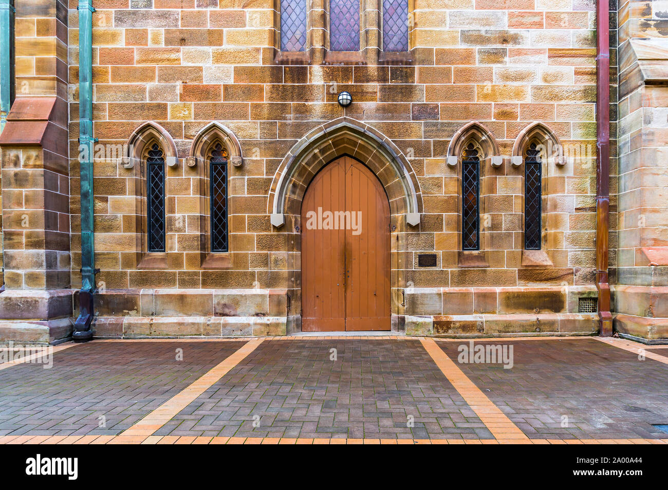 Gothic wooden old church door and narrow windows with color glass Stock ...