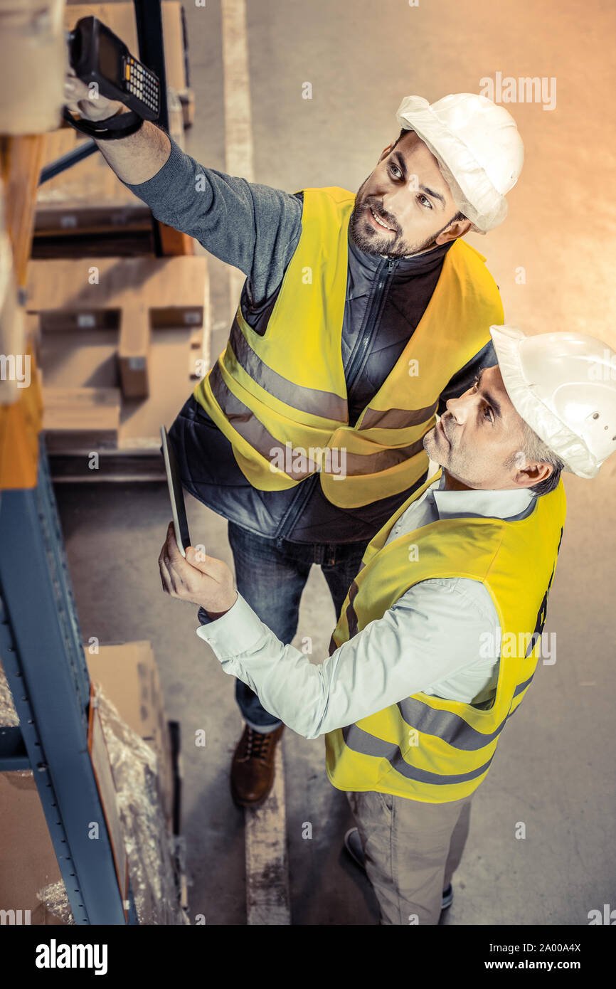 Top view of pleased man that checking warehouse Stock Photo - Alamy