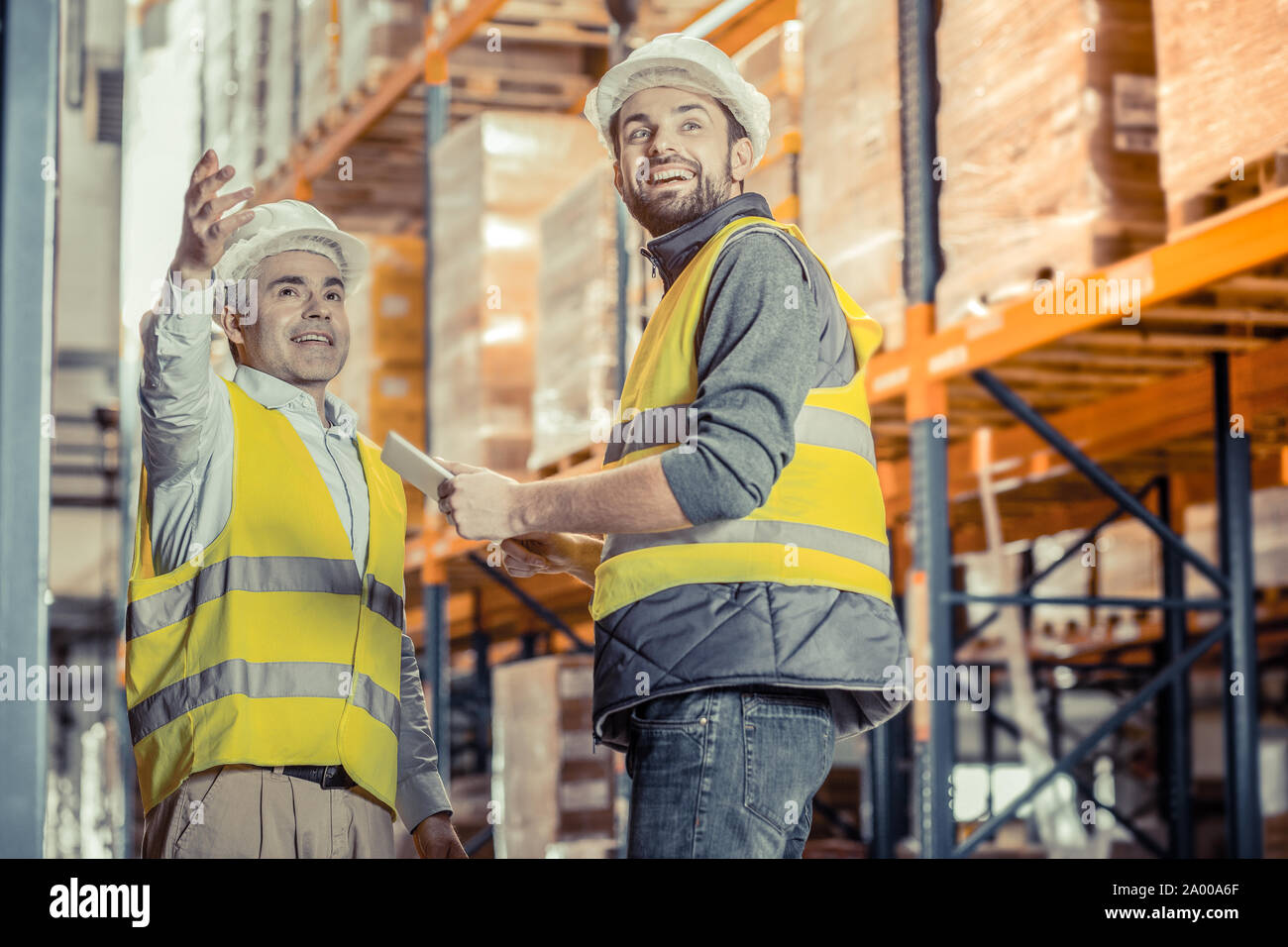 Positive delighted workers looking in one direction Stock Photo - Alamy