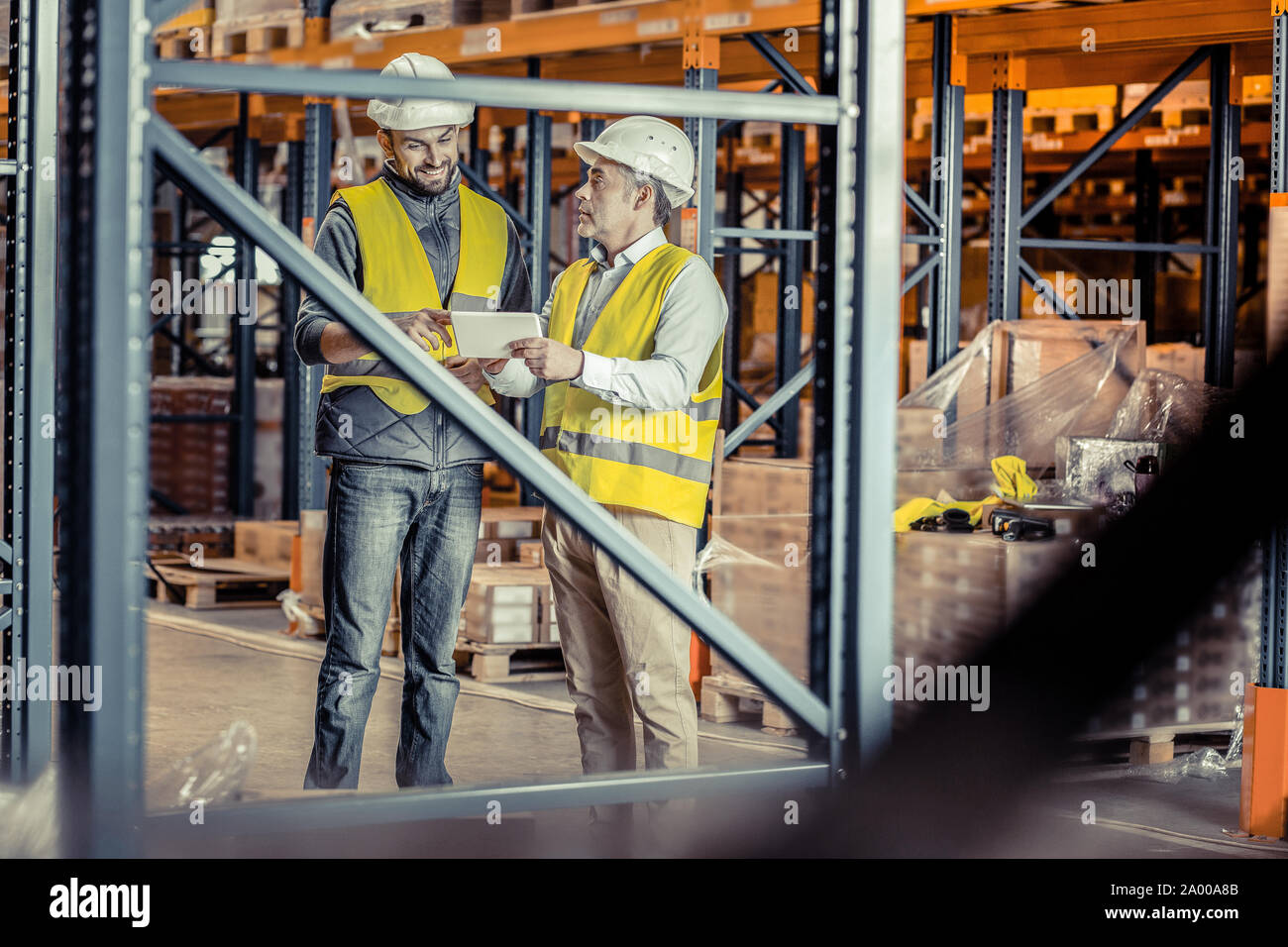 Positive delighted young man listening to his director Stock Photo - Alamy