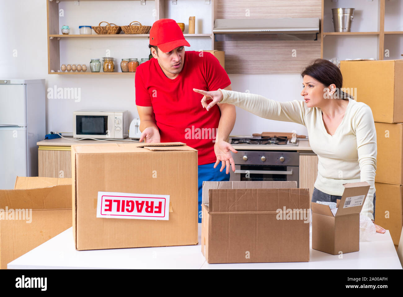 The young male contractor and female customer in moving concept Stock ...